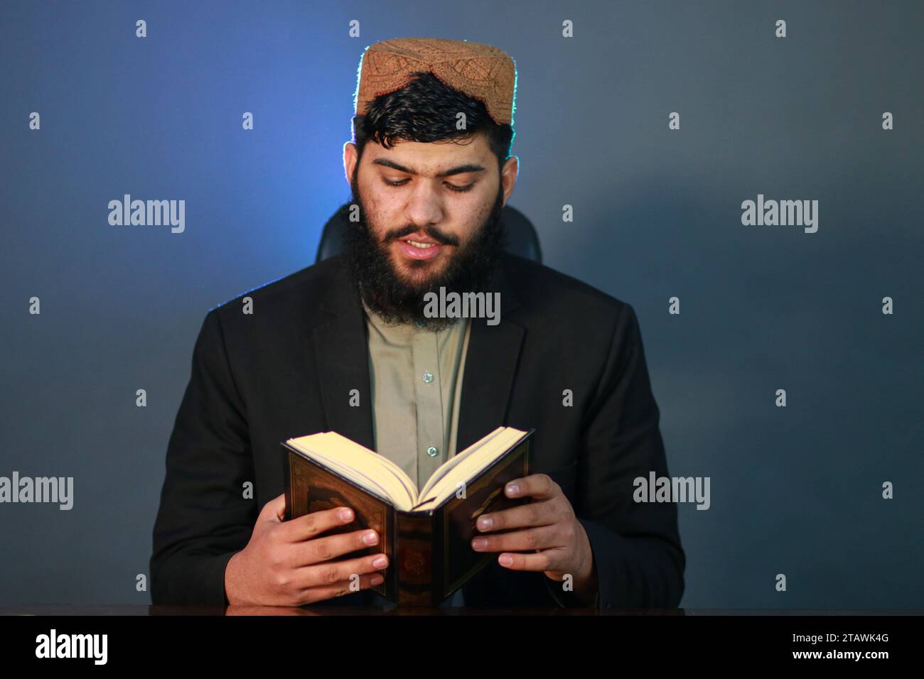 Muslim man reading holy Quran. Holy Quran in Hand with Arabic text ...
