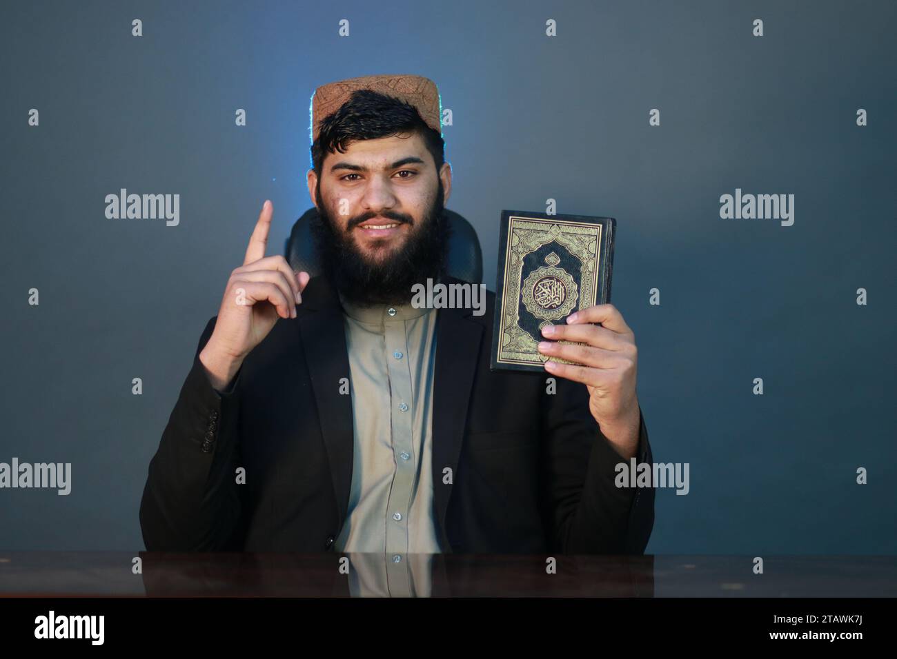 Muslim man reading holy Quran. Holy Quran in Hand with Arabic text ...
