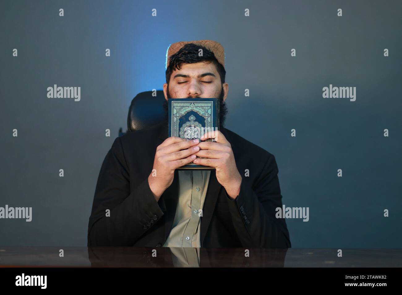 Muslim man reading holy Quran. Holy Quran in Hand with Arabic text ...