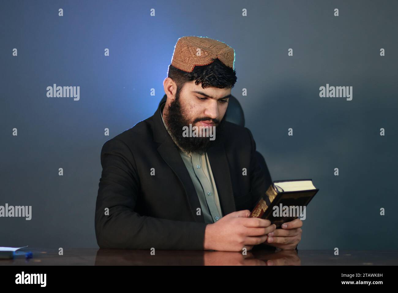 Muslim man reading holy Quran. Holy Quran in Hand with Arabic text ...
