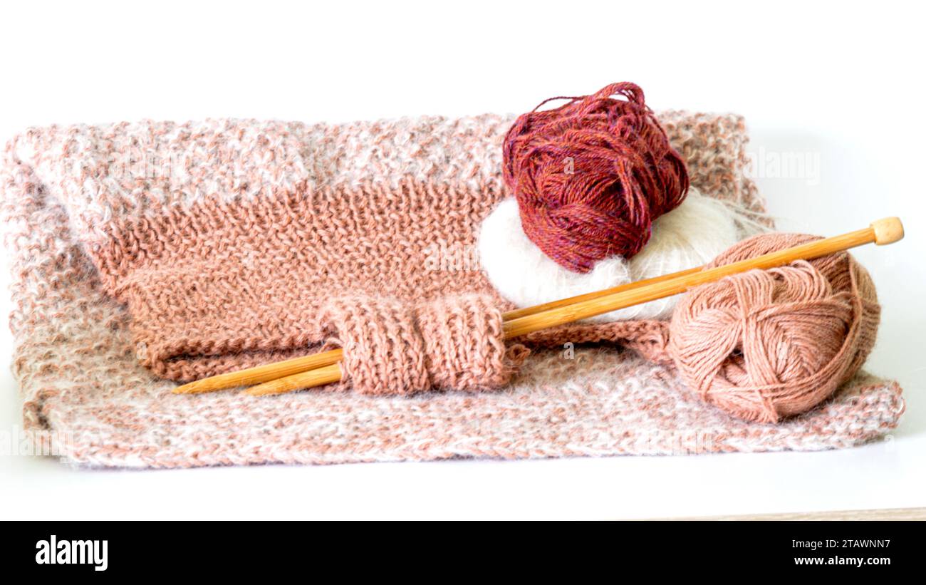knitted work on a white background, knitted texture, needlework, home ...