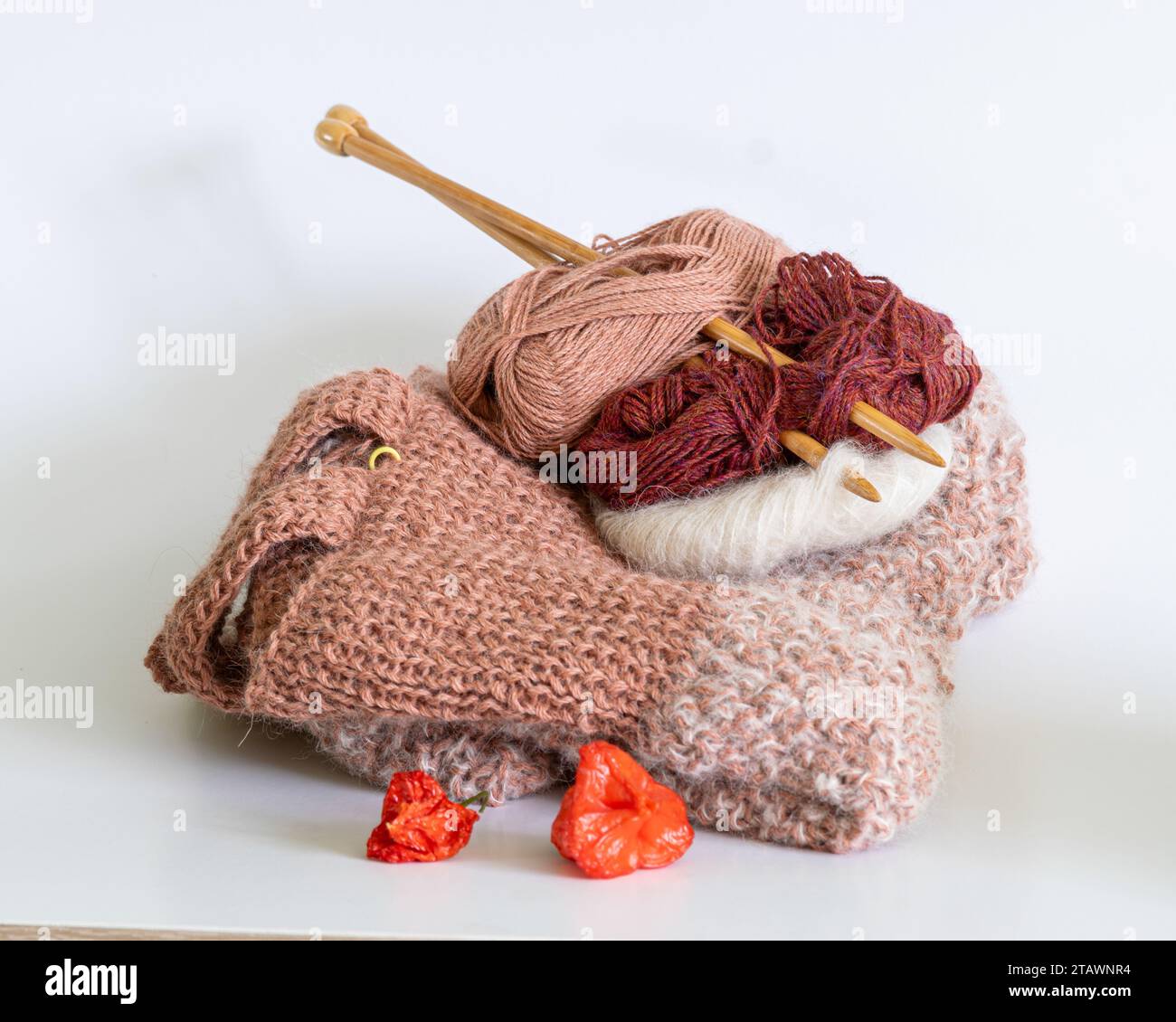 knitted work on a white background, knitted texture, needlework, home ...