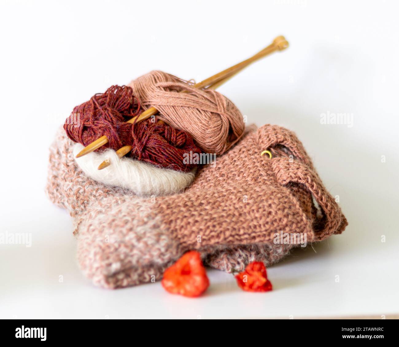 knitted work on a white background, knitted texture, needlework, home ...