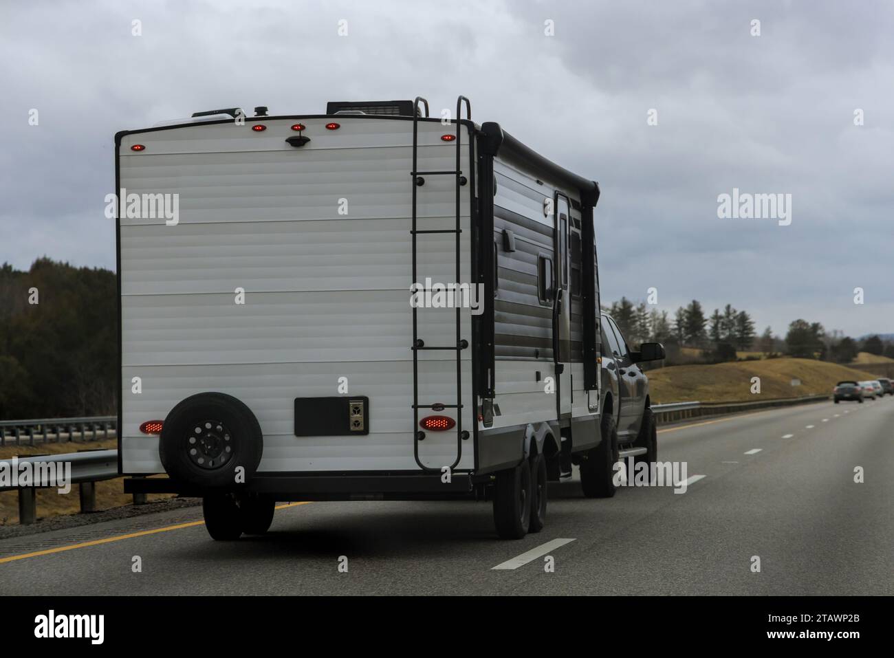 Traveling by caravan trailer on freeway road, family vacation, holiday ...