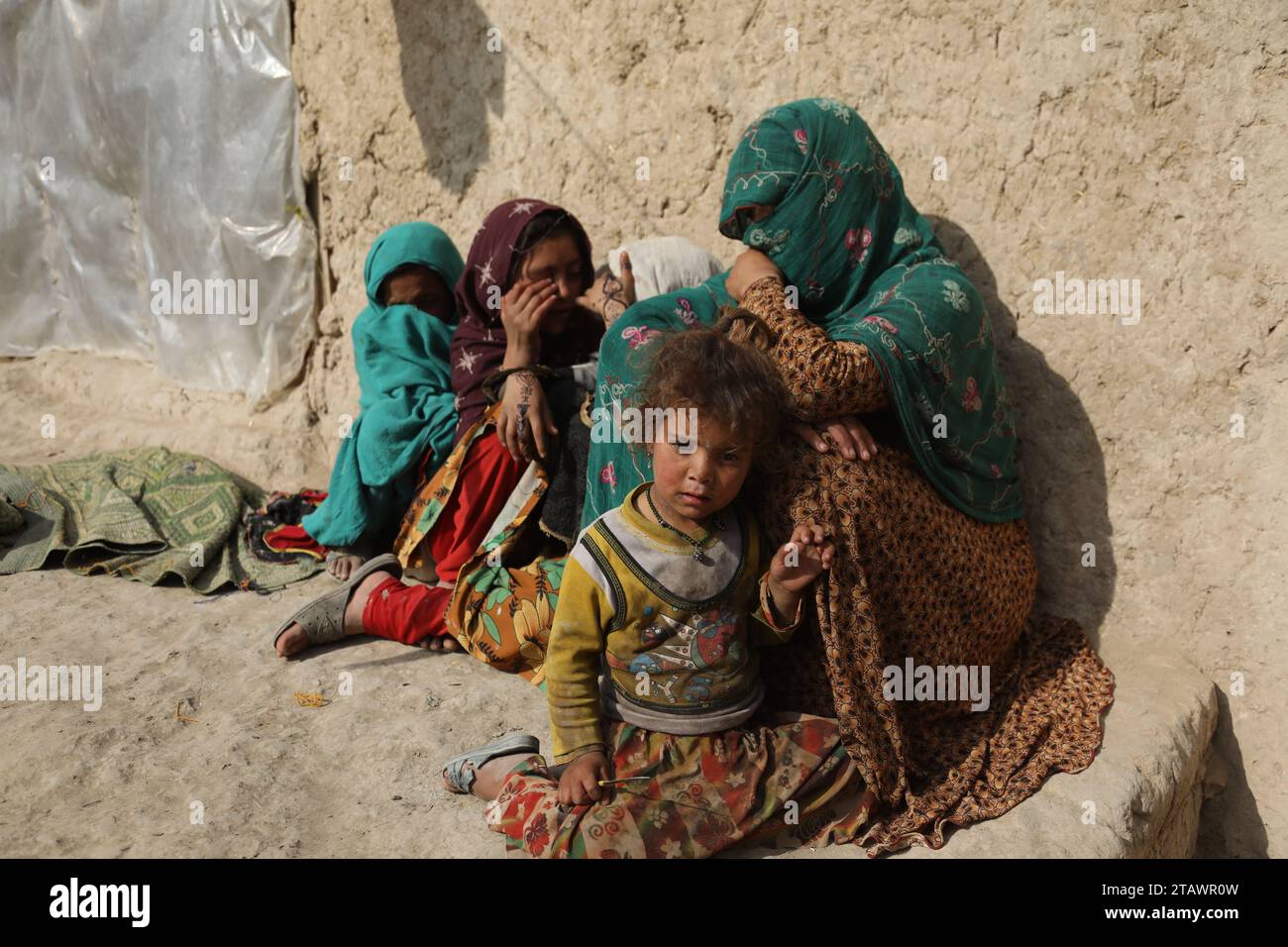 A sad widow in need, accompanied by her children, represents Afghan ...