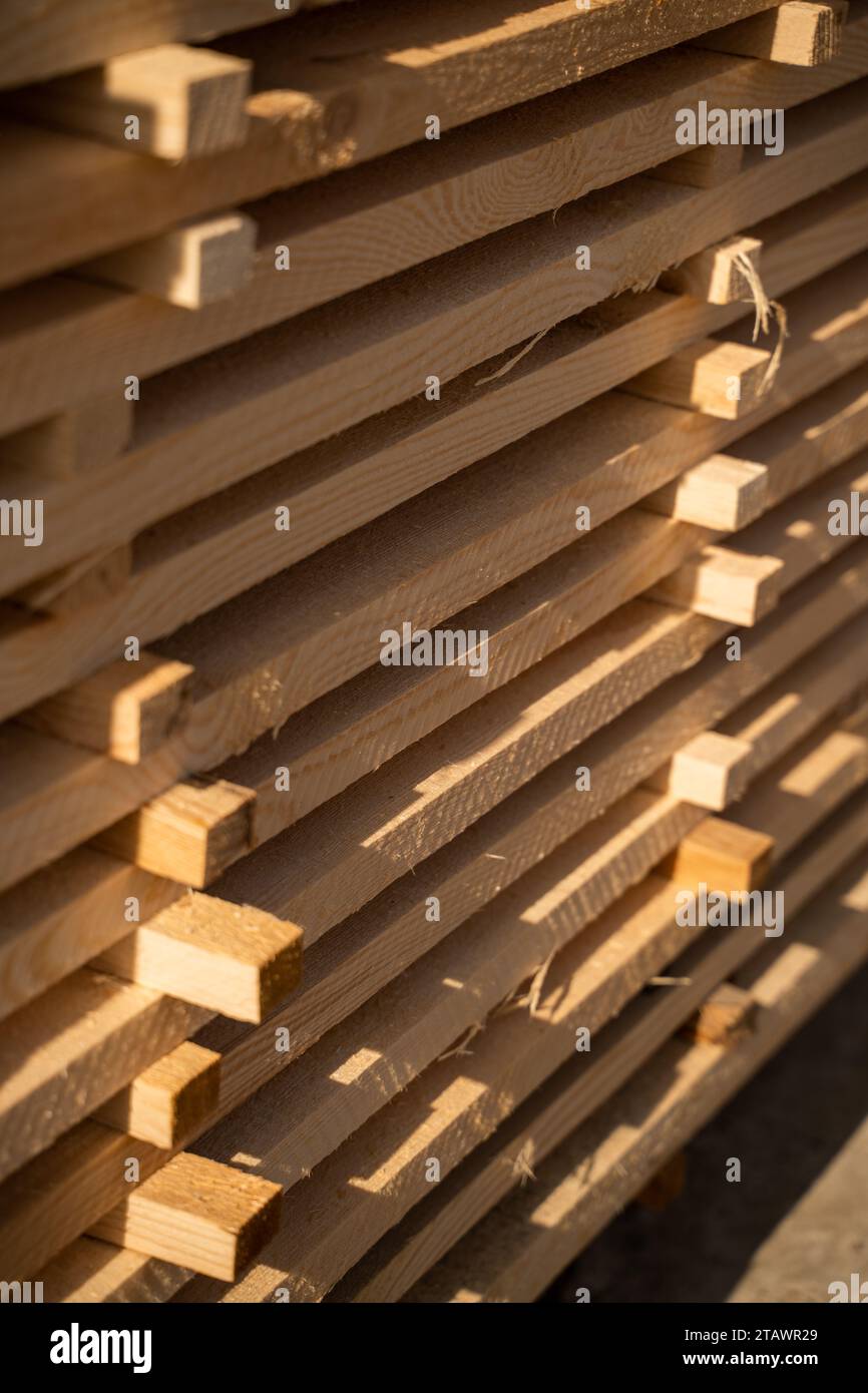 Wooden planks and beams at a outdoor lumber warehouse in a woodworking ...