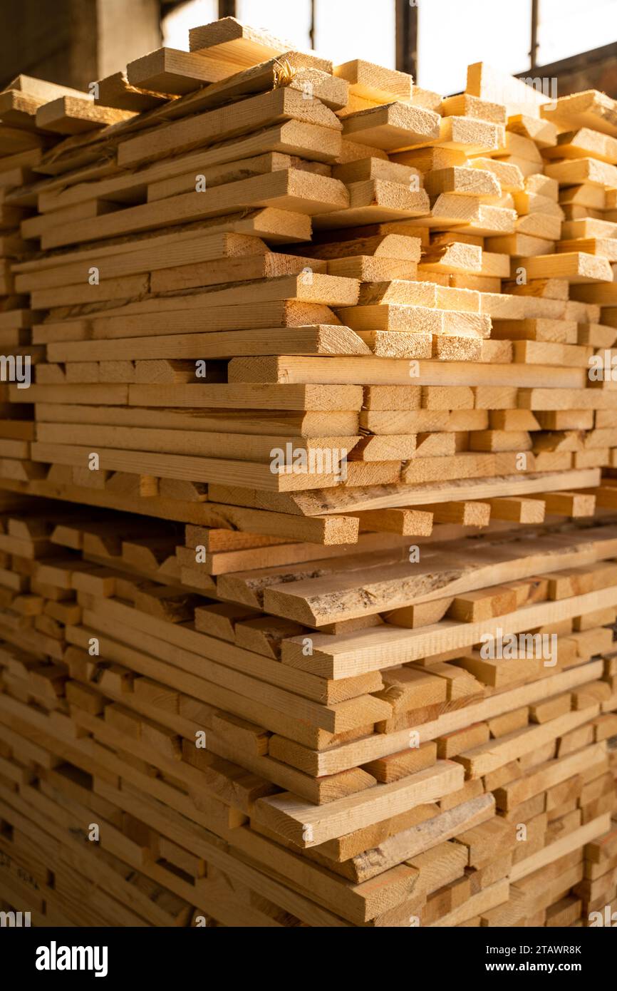 Wood processing. Stacked wooden boards at lumber warehouse in a ...