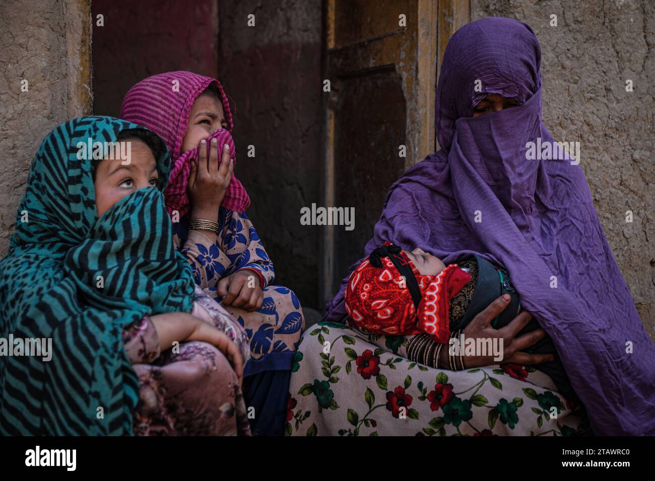 A sad widow in need, accompanied by her children, represents Afghan ...