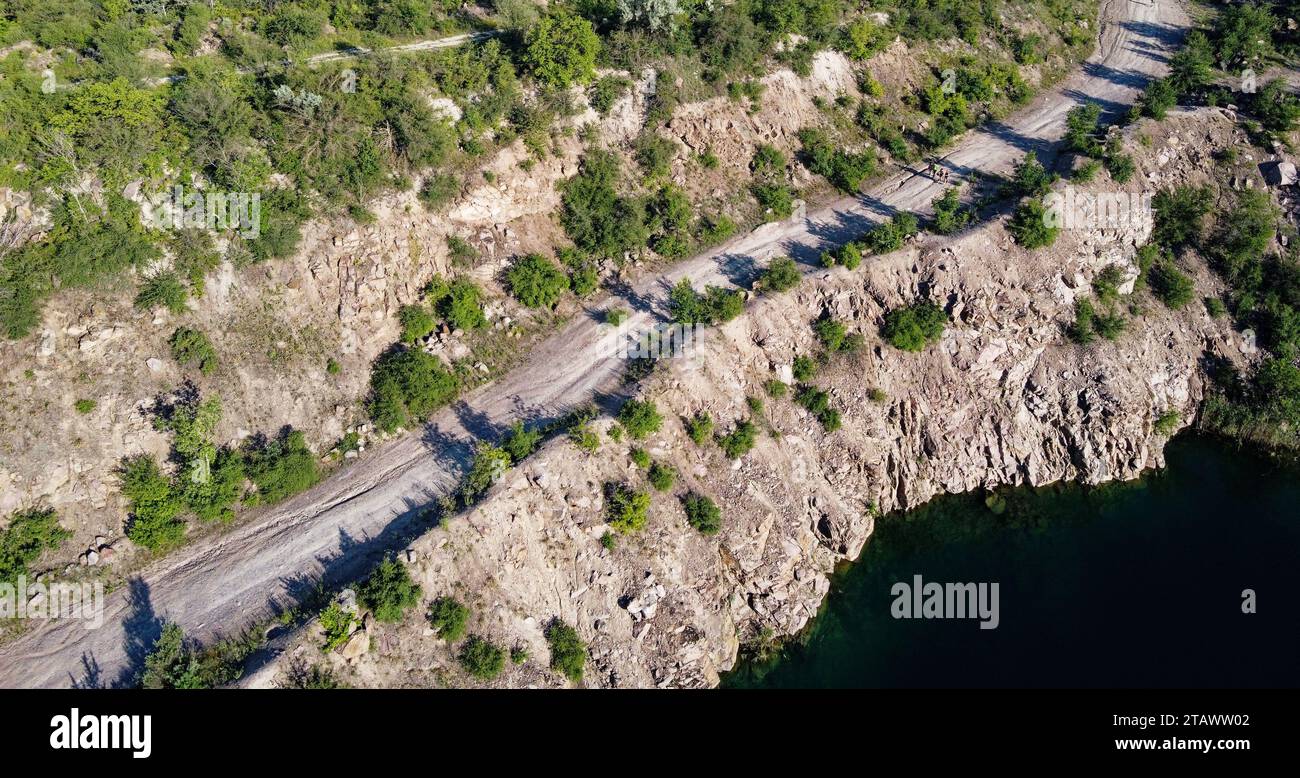 Rocky terrain overgrown with sparse vegetation, aerial view. Summer ...
