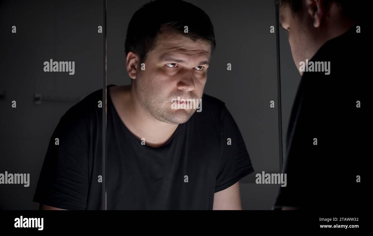 Angry frustrated man looking at his reflection in mirror. Concept of ...