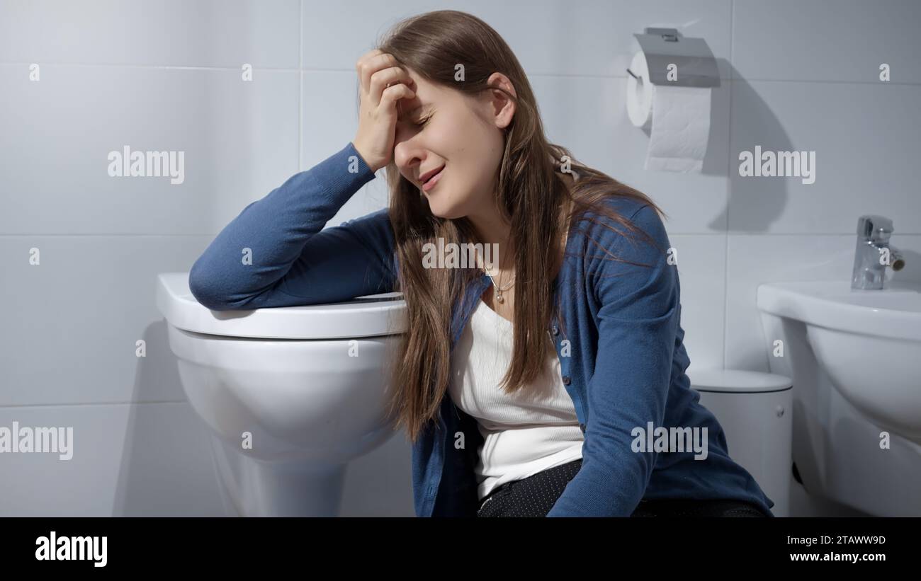 Crying young woman having problems and stress in life sitting on floor ...