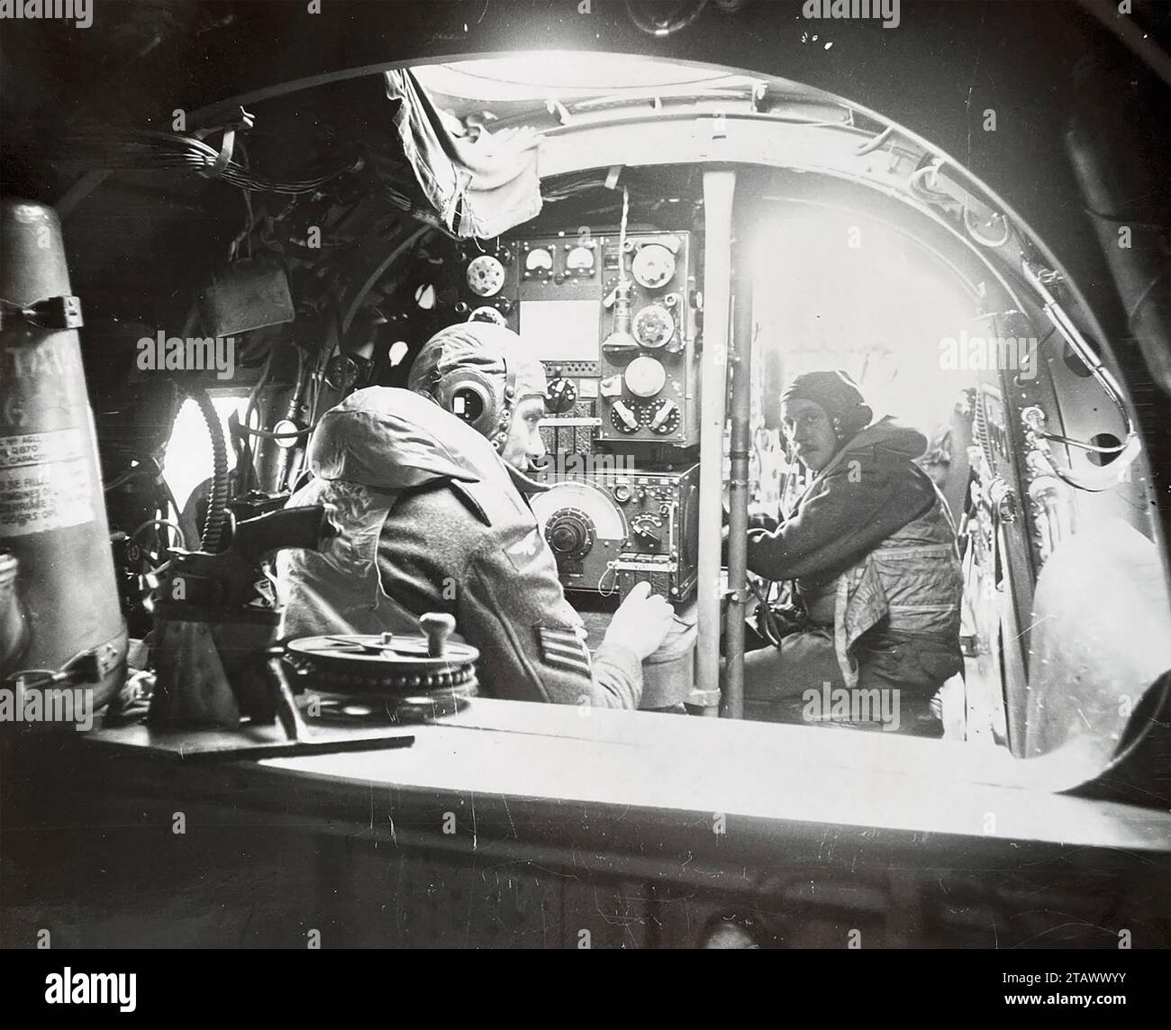 LANCASTER BOMBER interior about 1944 with radio operator at left and ...