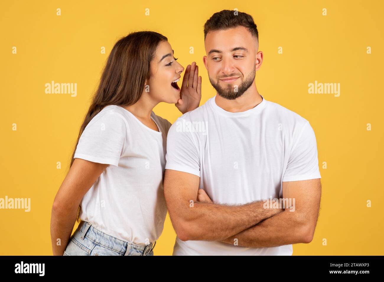 Young man whispers in ear hi-res stock photography and images - Alamy