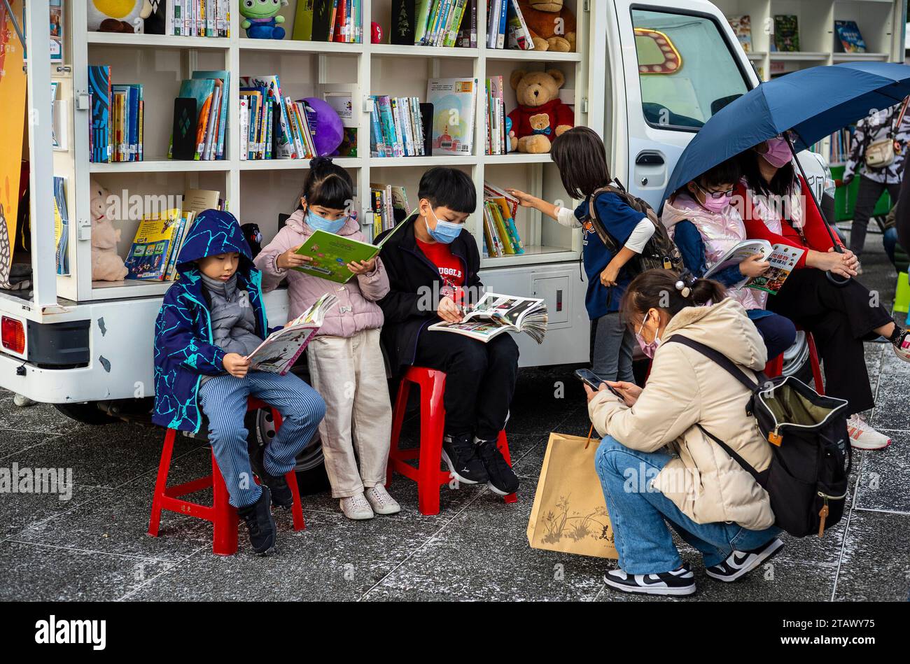 Taipei. 03rd Dec, 2023. Children read books at mobile library in Taipei ...