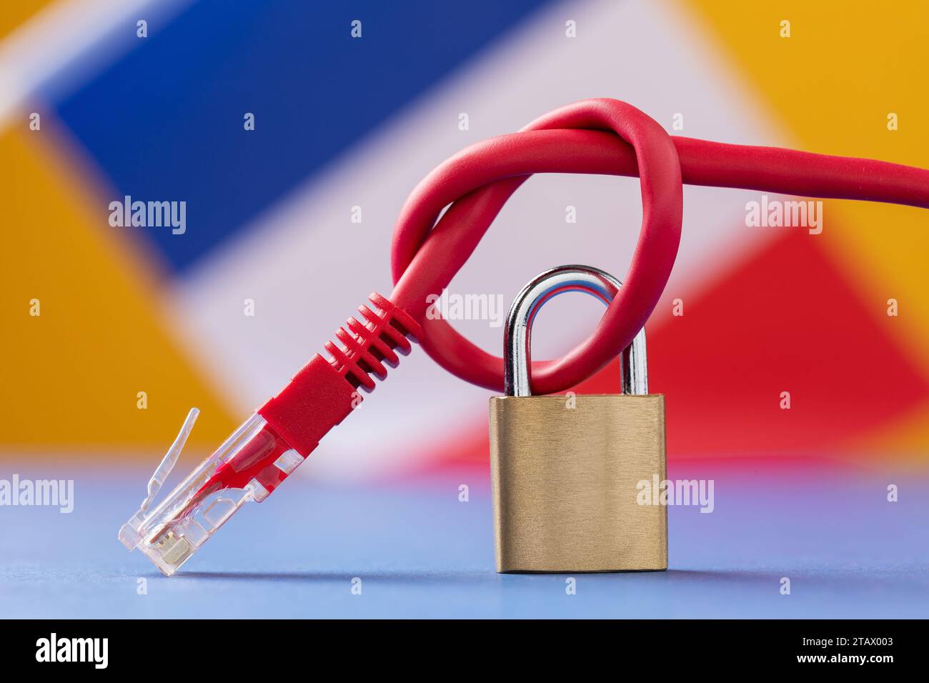 A closed lock on a tied network wire into a knot against the background ...