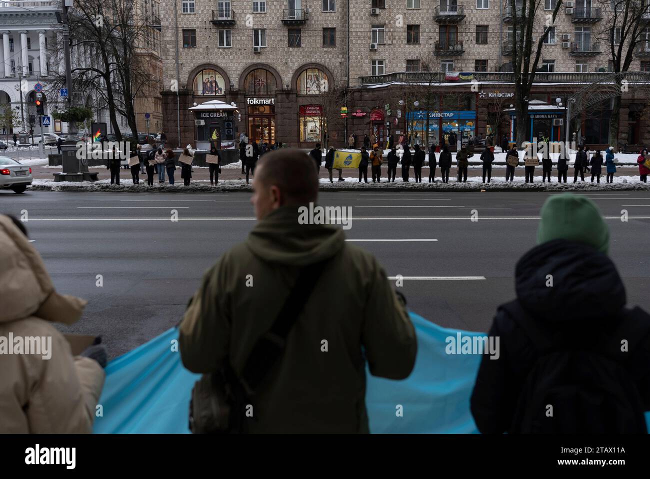 People hold a giant Ukrainian flag, during a demonstration in central ...