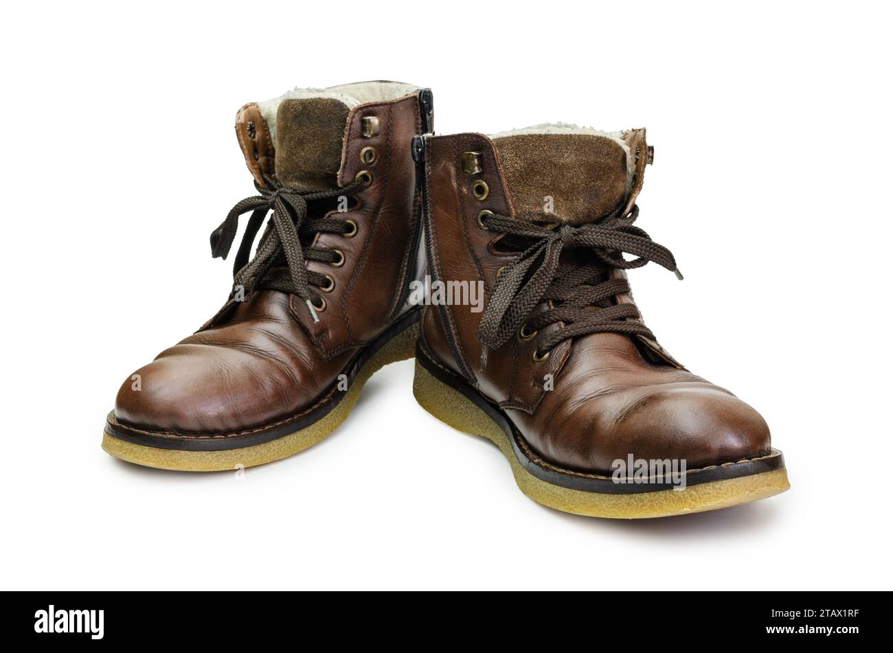 Close-up of a pair of old boots, brown in color, on an isolated white ...
