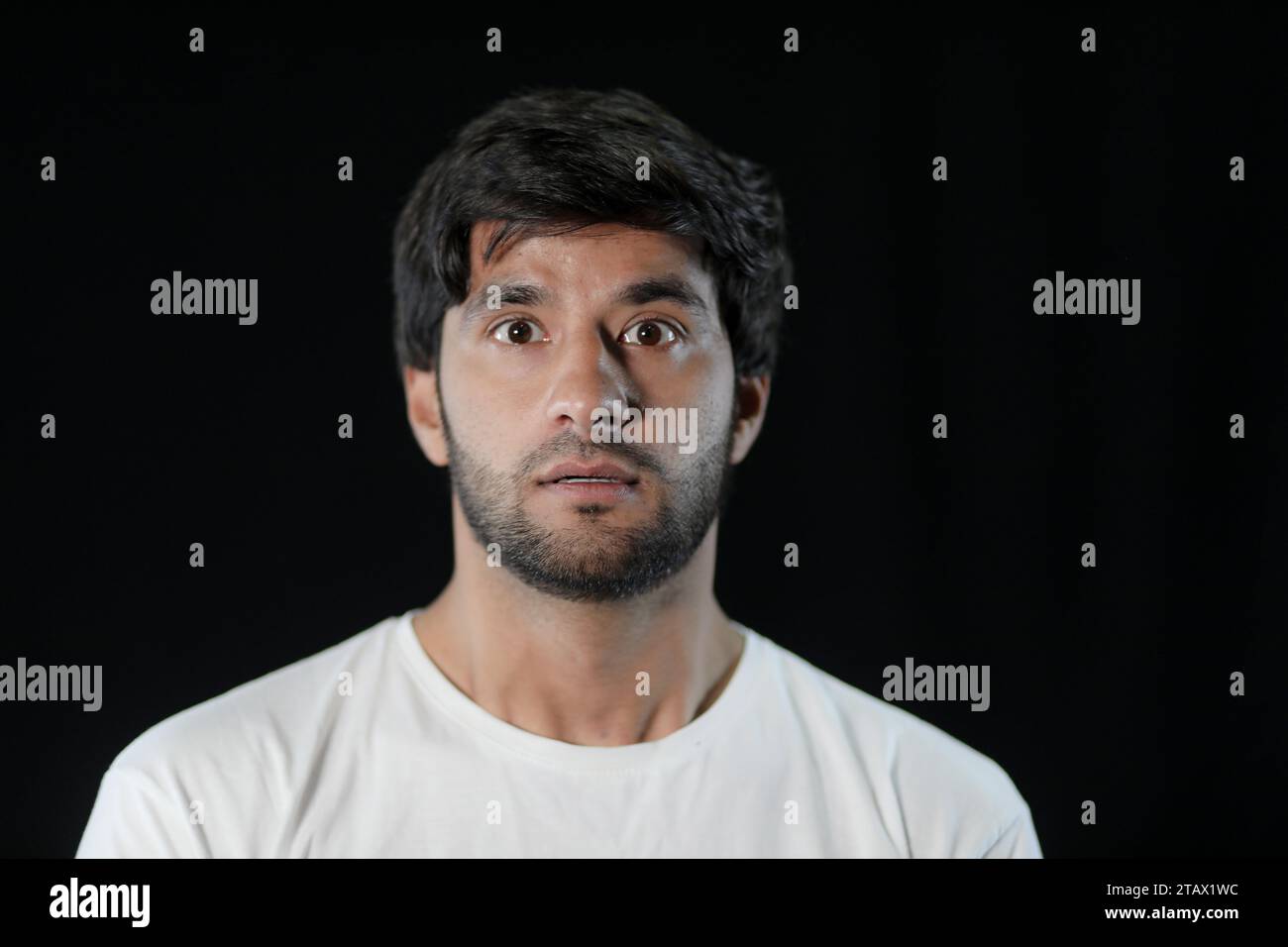 Scared man against dark background, Portrait of a young frightened man ...