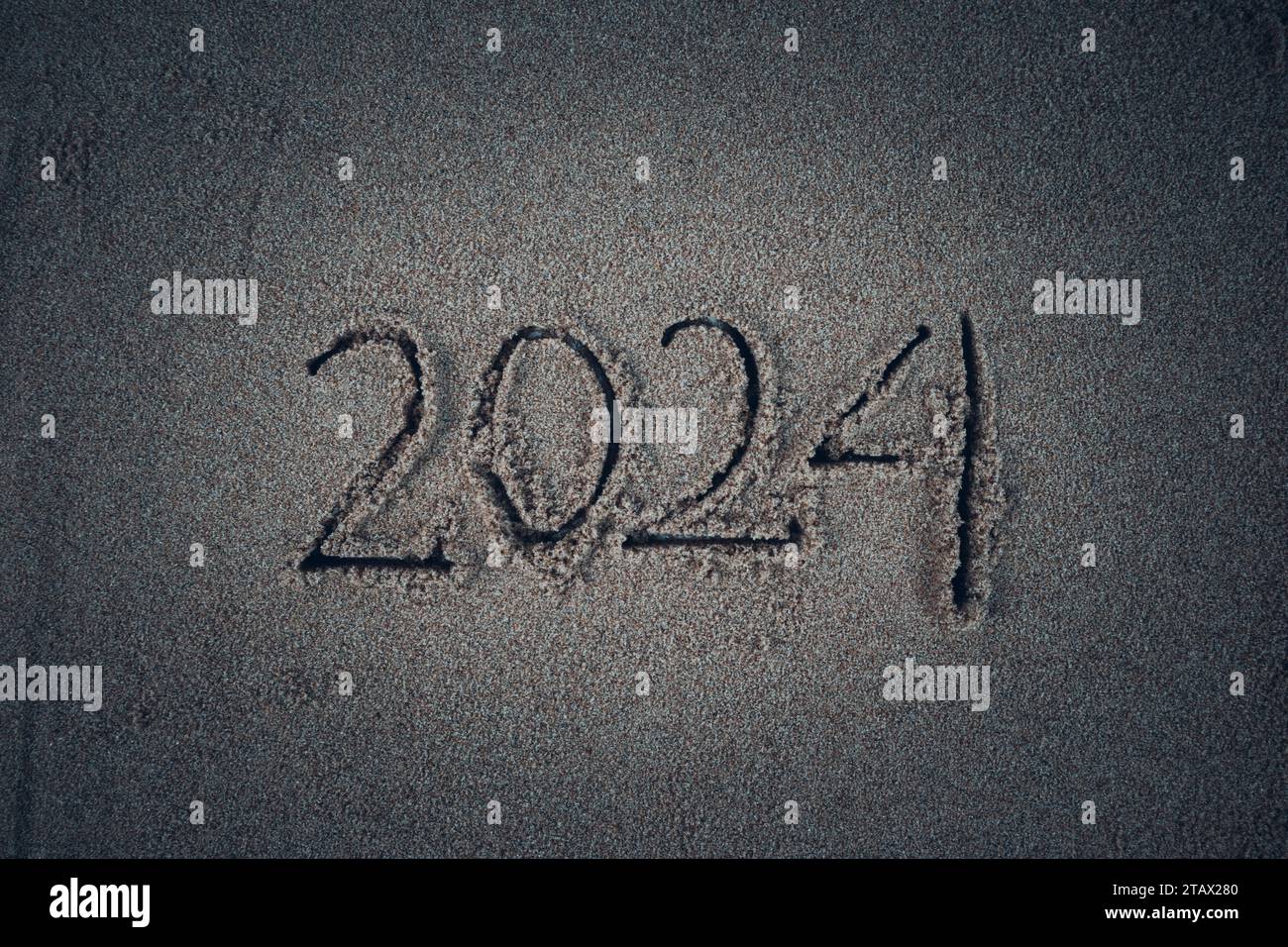 Handwritten 2024 on clean beach sand. Happy New Year Stock Photo - Alamy