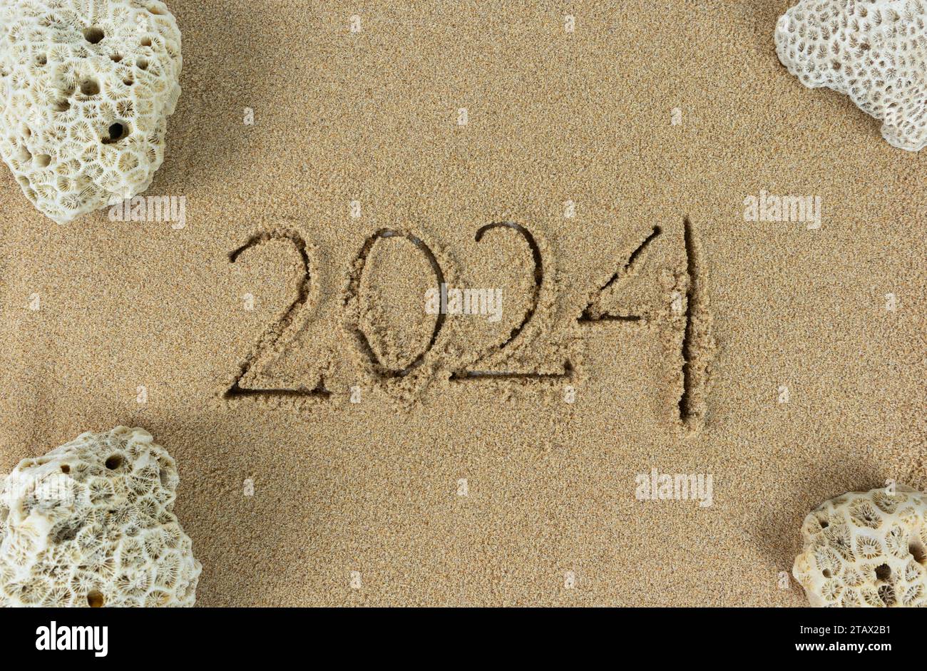 Handwritten 2024 on clean beach sand. Happy New Year Stock Photo - Alamy