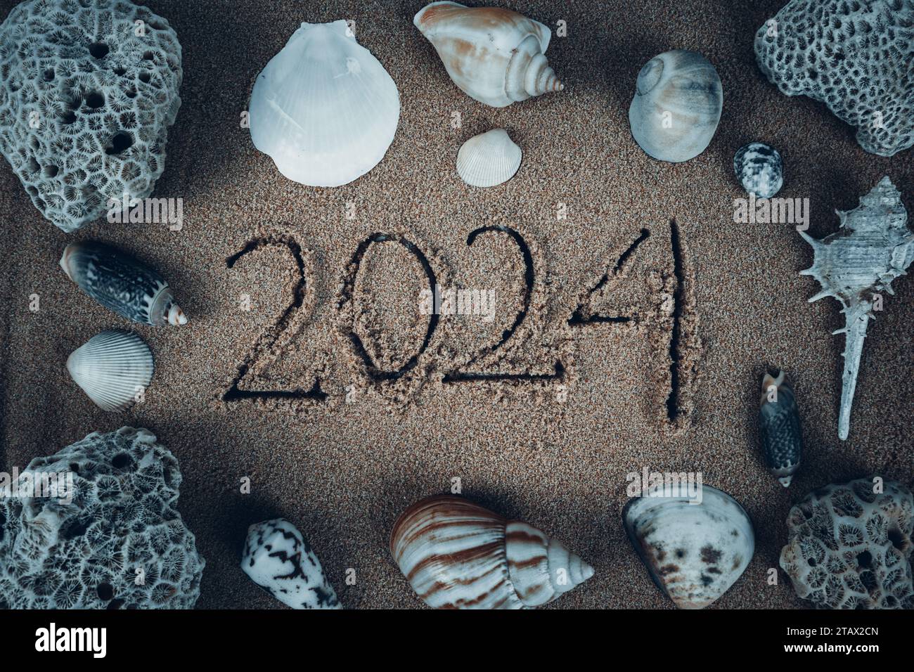 Handwritten 2024 on clean beach sand. Happy New Year Stock Photo - Alamy