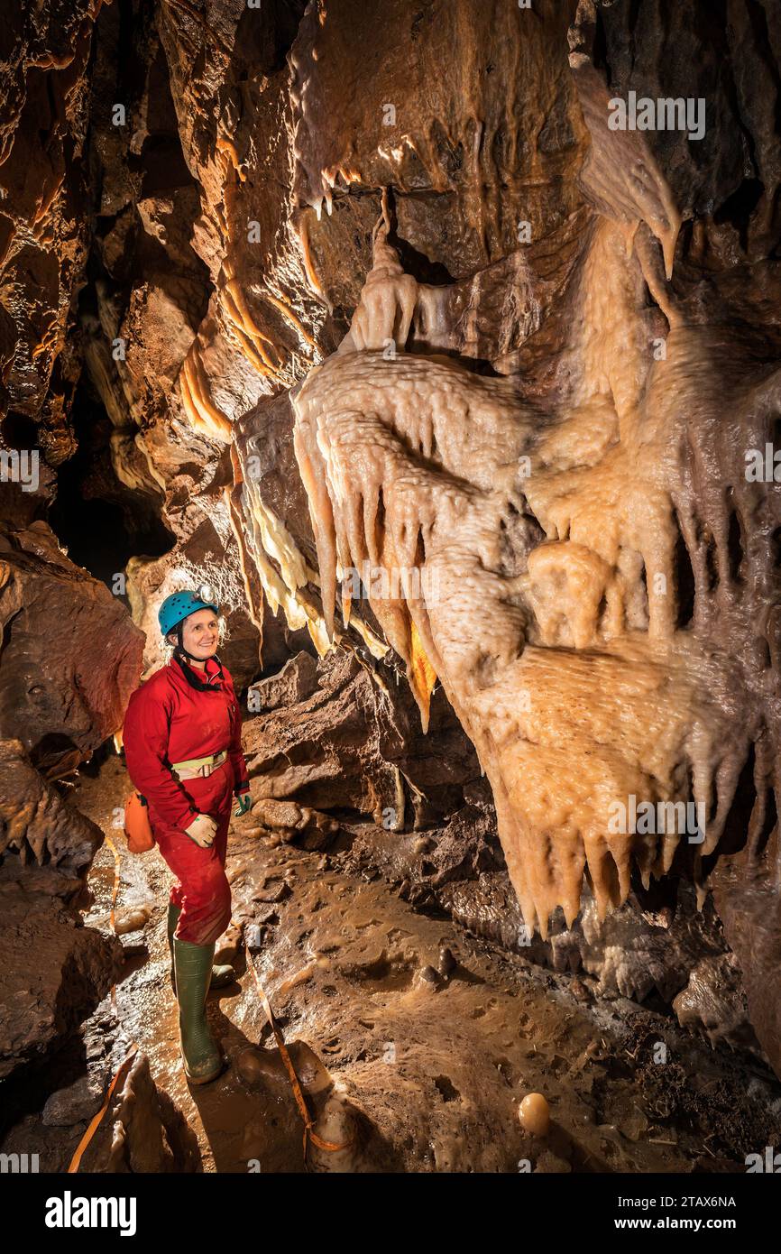Female caver admiring cave formations, Somerset, Mendip, UK Stock Photo ...