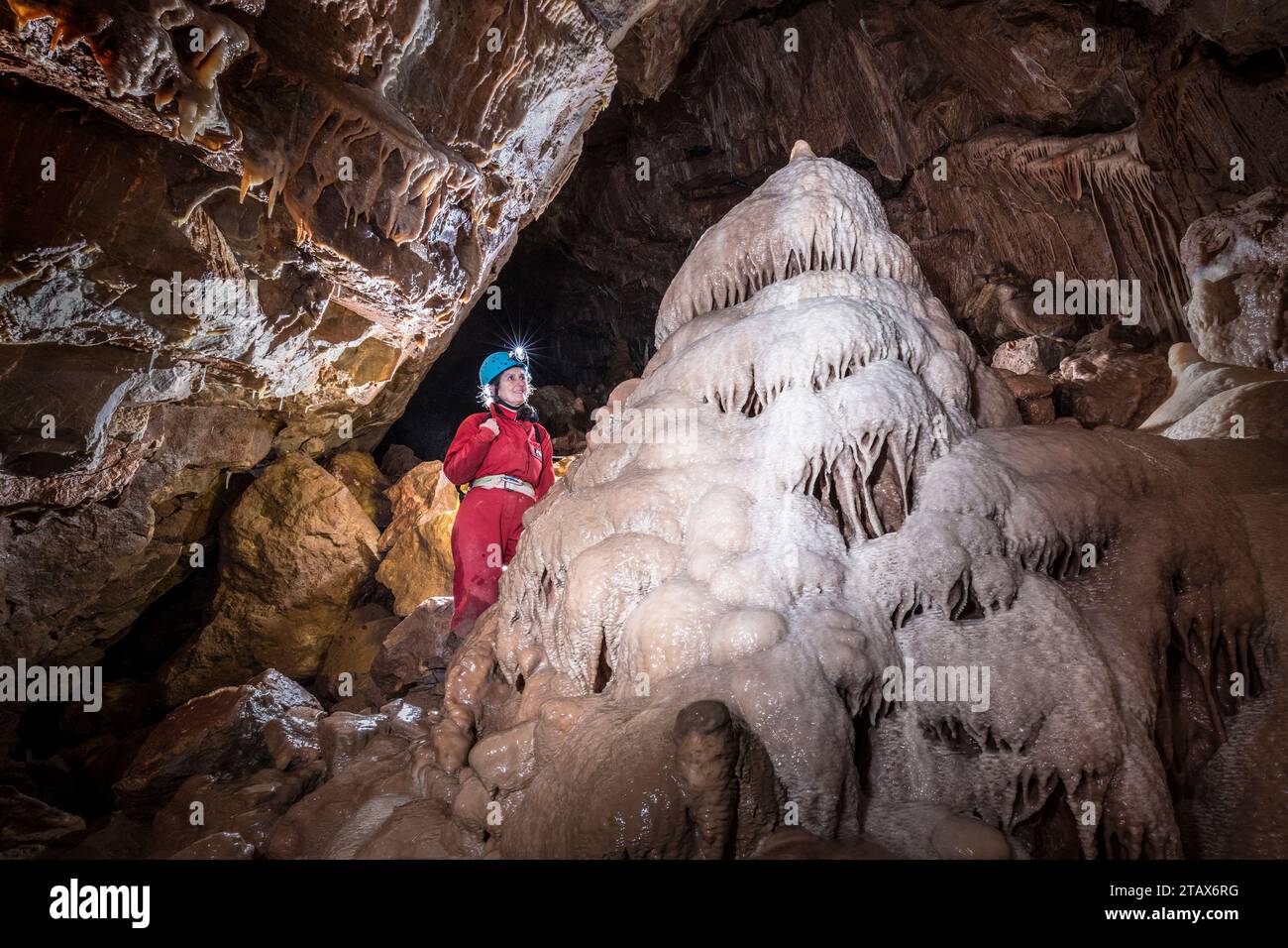 Female caver admiring cave formations, Somerset, Mendip, UK Stock Photo ...