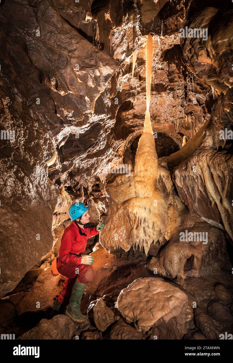 Female caver admiring cave formations, Somerset, Mendip, UK Stock Photo ...