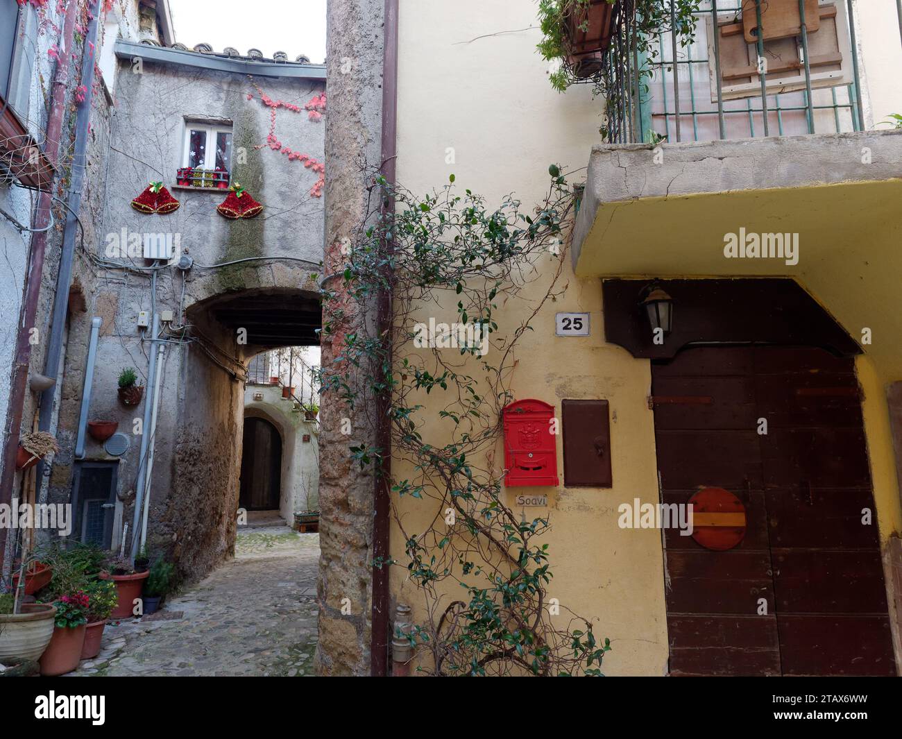 Quaint street with archway and houses in the historical town of Calcata ...