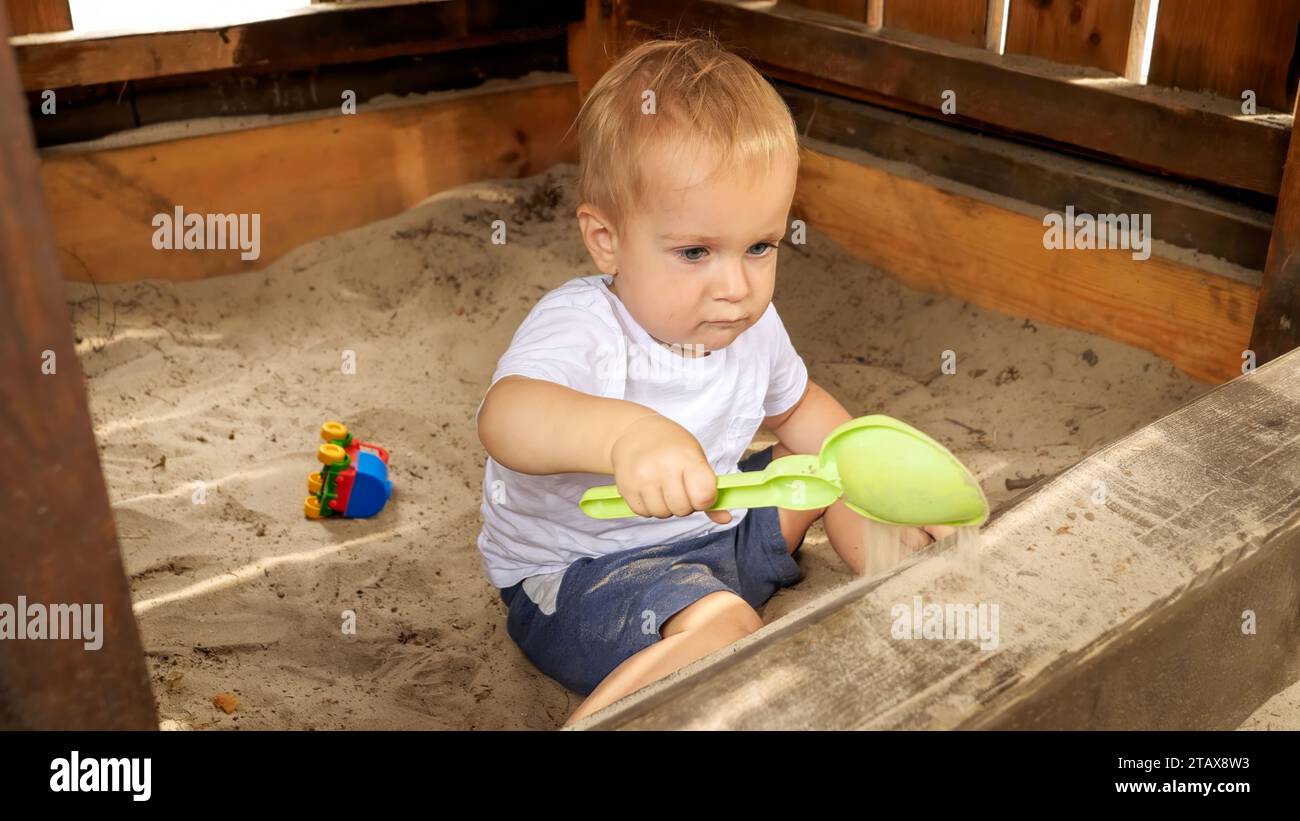 Toddler digging sand hand hi-res stock photography and images - Alamy