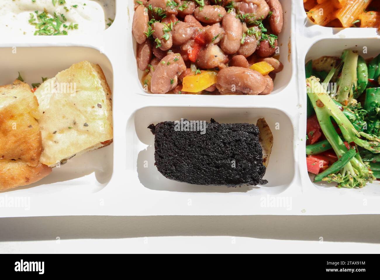 Tasty brownie in a continental lunch dinner platter with healthy salads ...