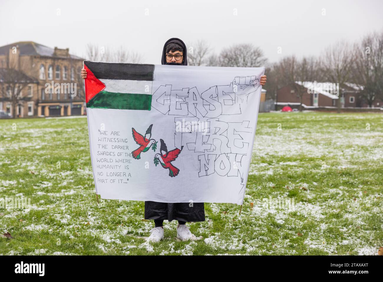 Bradford, UK. 03 December 2023. Mohammed, 30 poses with a "Cease Fire ...