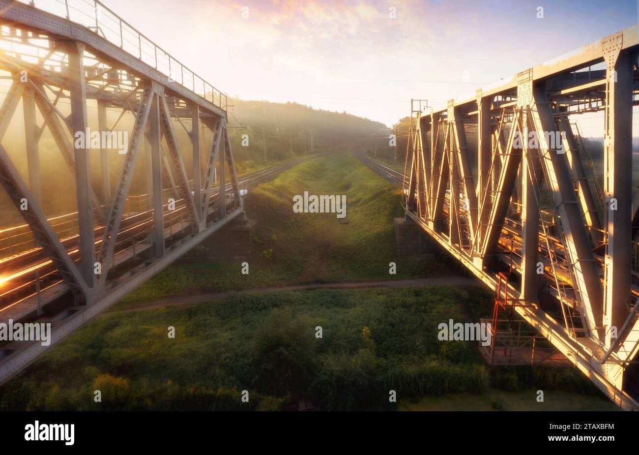 Railroad bridges at sunset with morning fog Stock Photo - Alamy