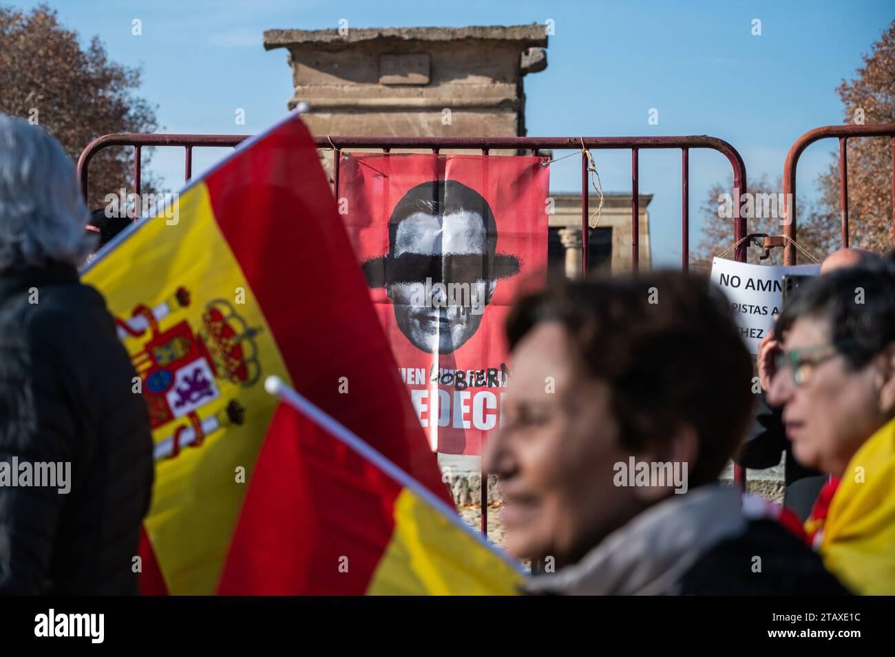 Madrid, Spain. 03rd Dec, 2023. People carrying Spanish flags walk past ...