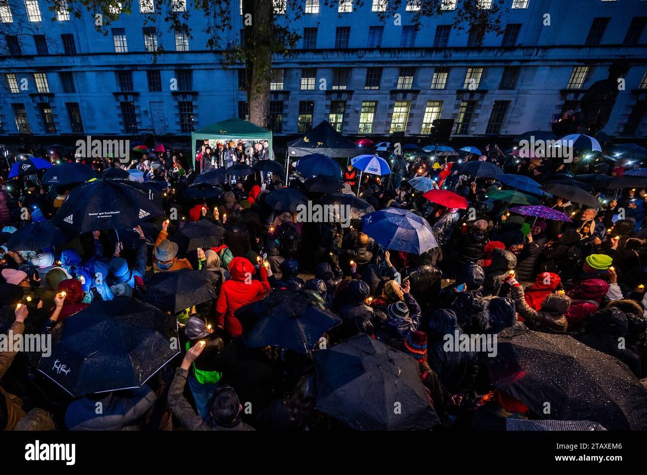 London, UK. 3rd Dec, 2023. Candles and phone were held aloft in ...