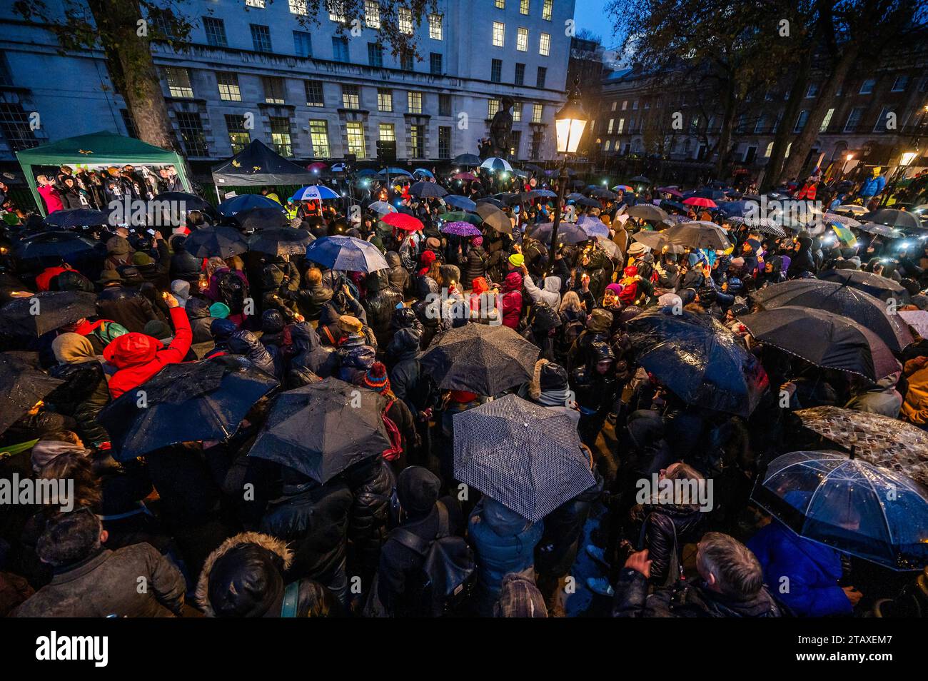 London, UK. 3rd Dec, 2023. Candles and phone were held aloft in ...