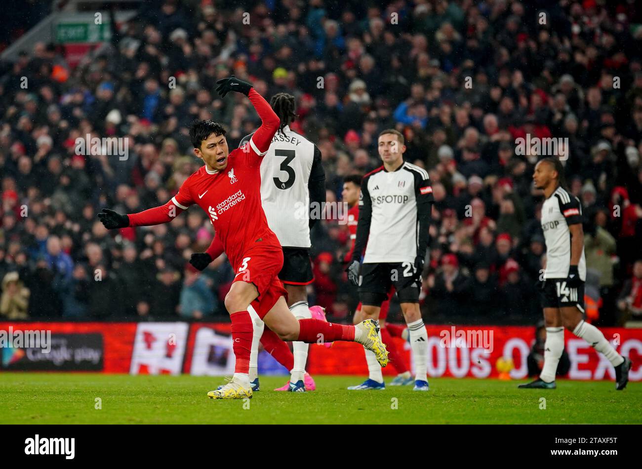 Liverpool's Wataru Endo (left) celebrates scoring his sides third goal ...