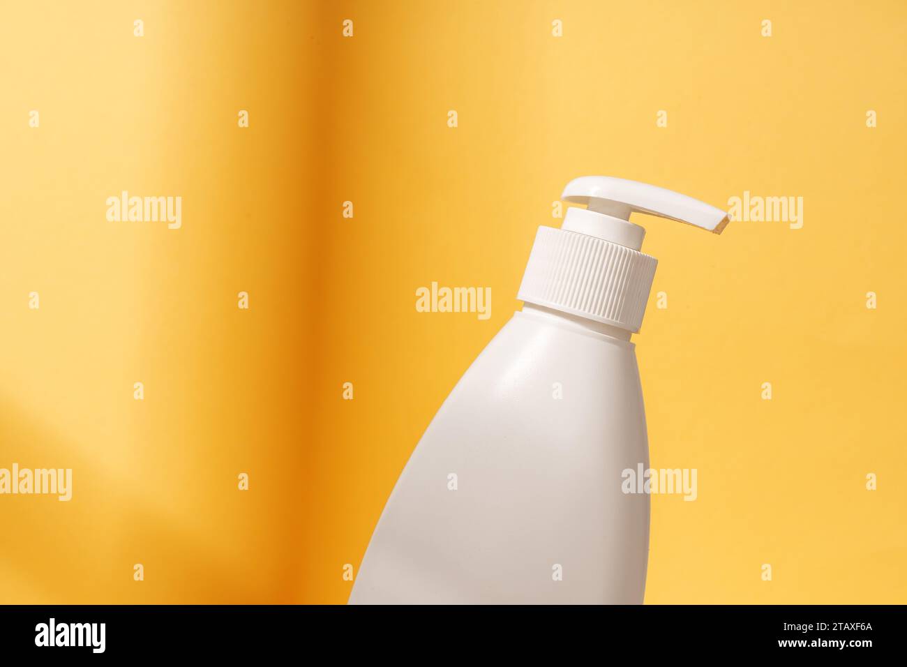 Bottle of sunscreen lotion against orange background Stock Photo - Alamy