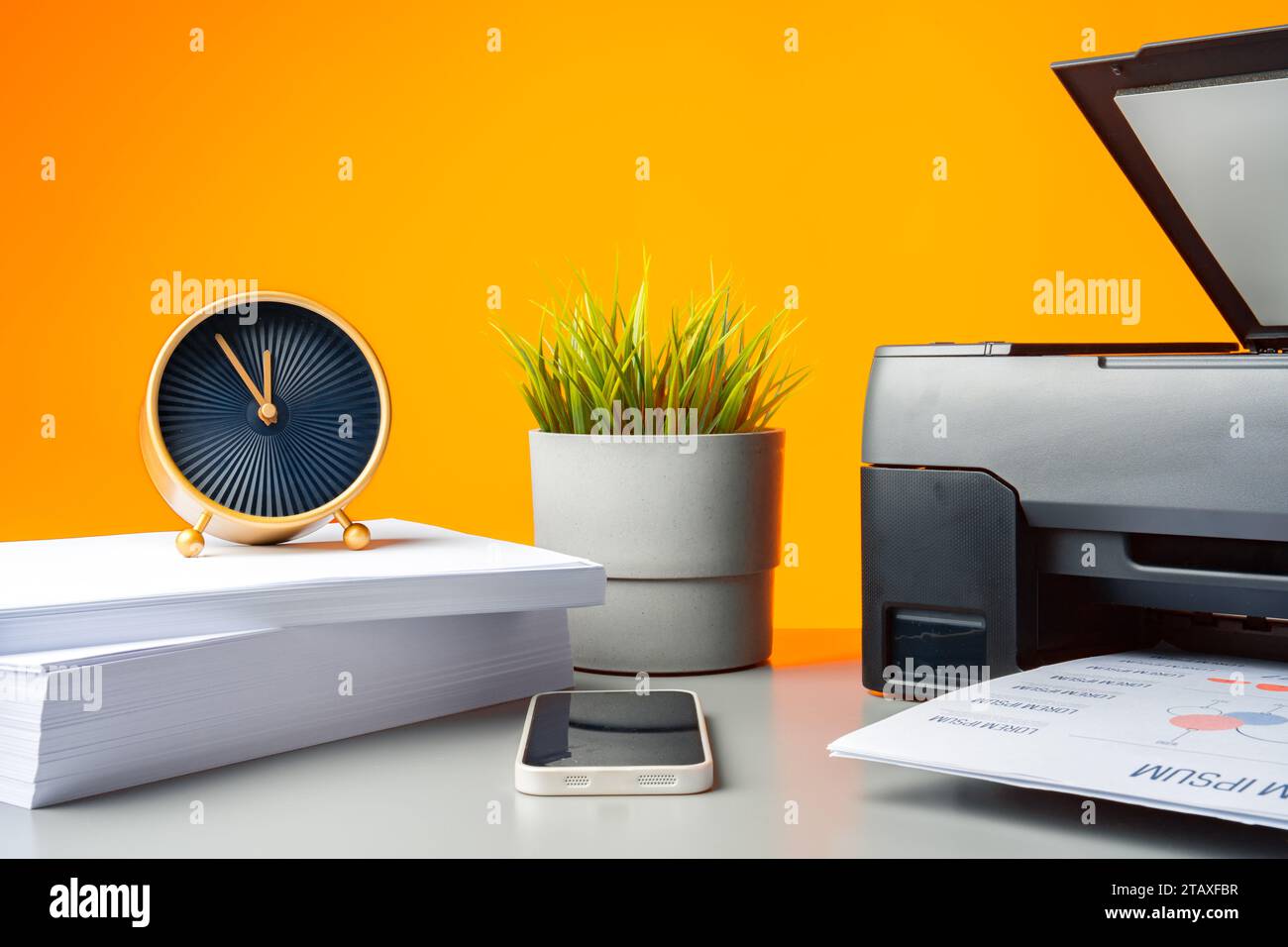 Laser printer on desk against yellow background Stock Photo - Alamy