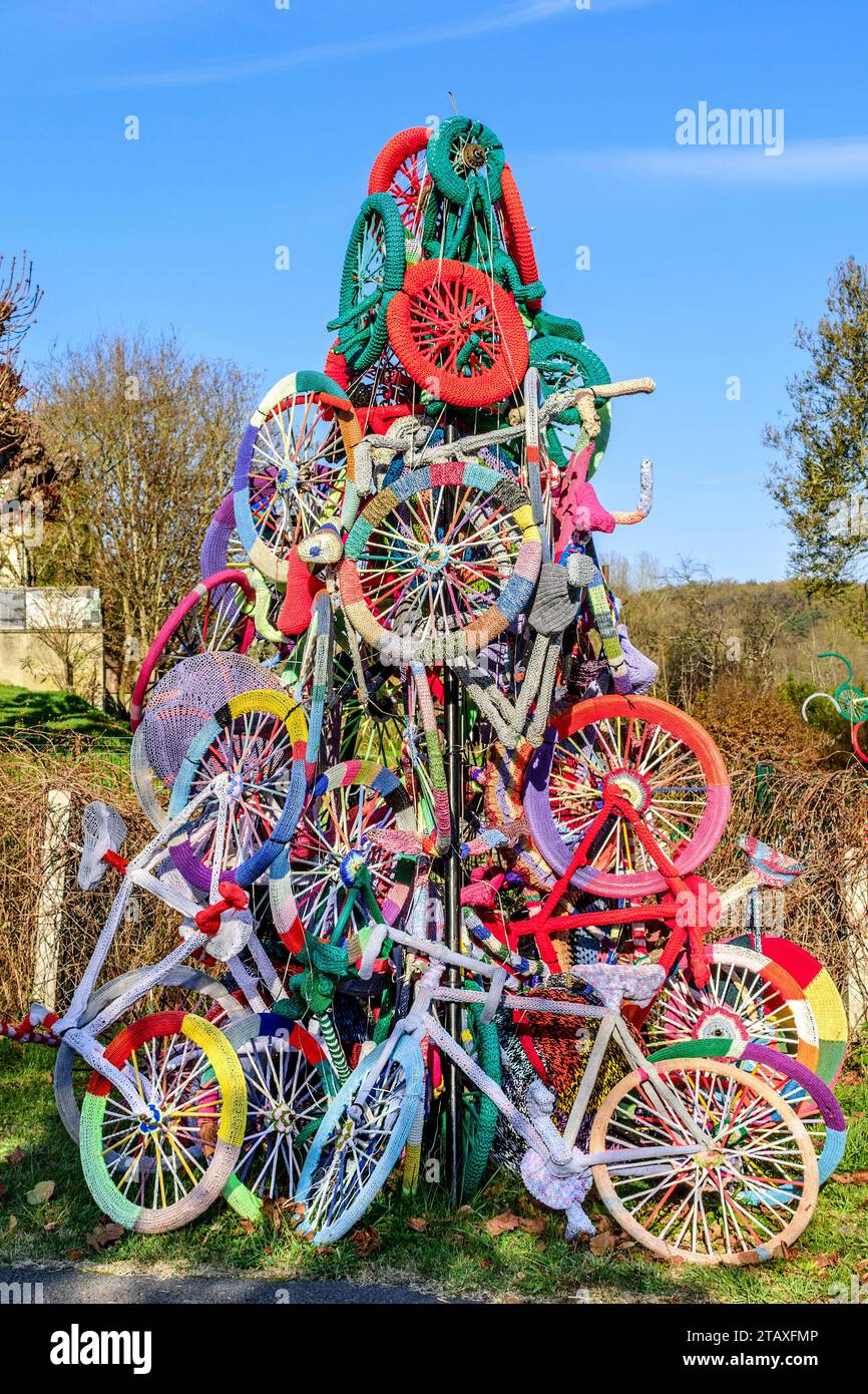 Tall stack of bicycles and wheels covered in knitting and crochet as ...