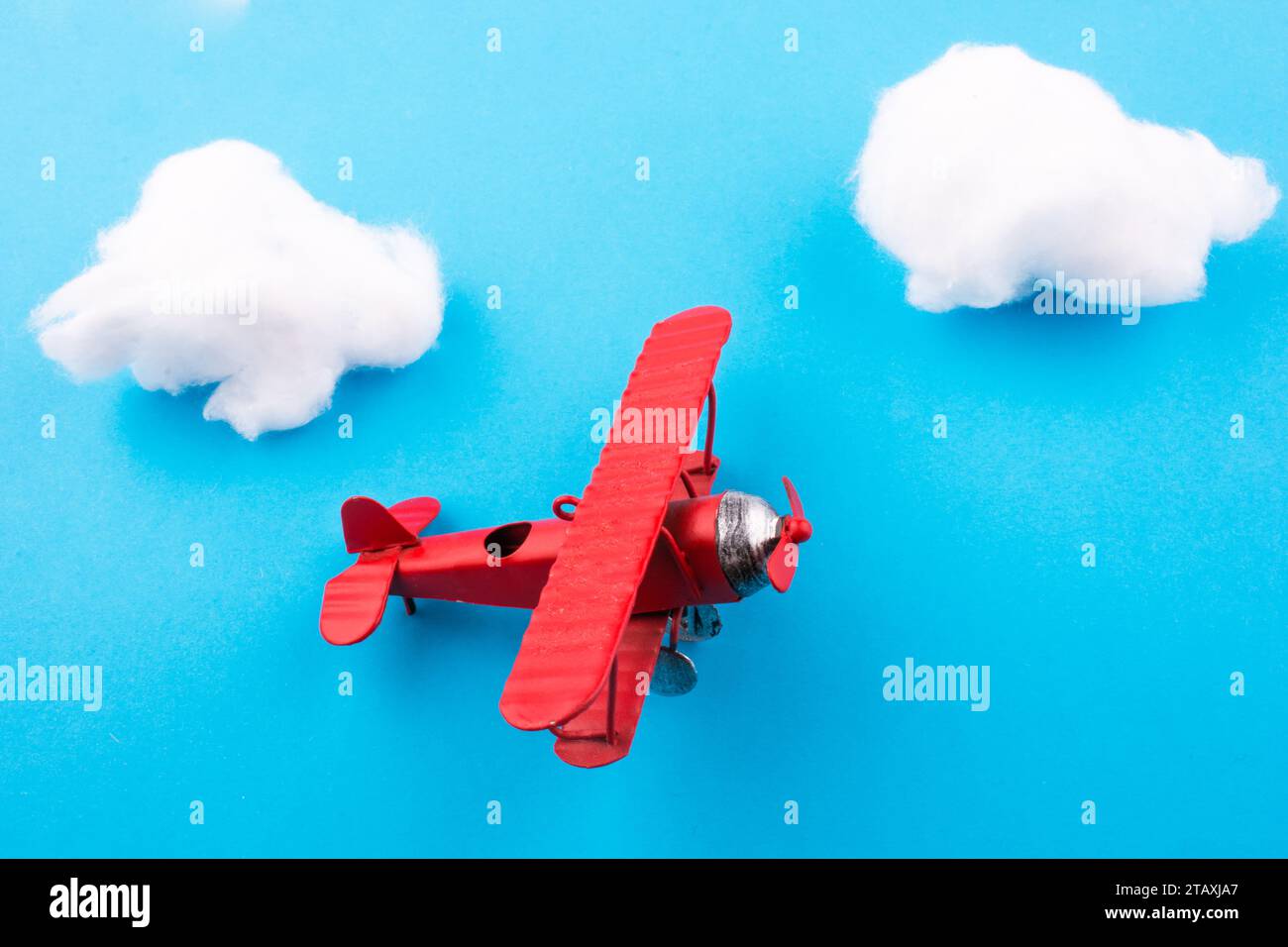 Retro styled little red model airplane in sky Stock Photo - Alamy