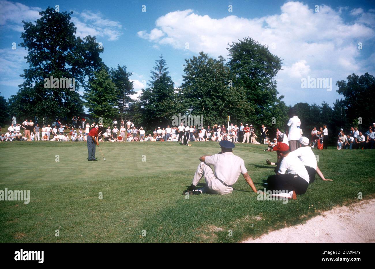 AUGUST, 1958: General view of the crowd watching the putted ball roll ...