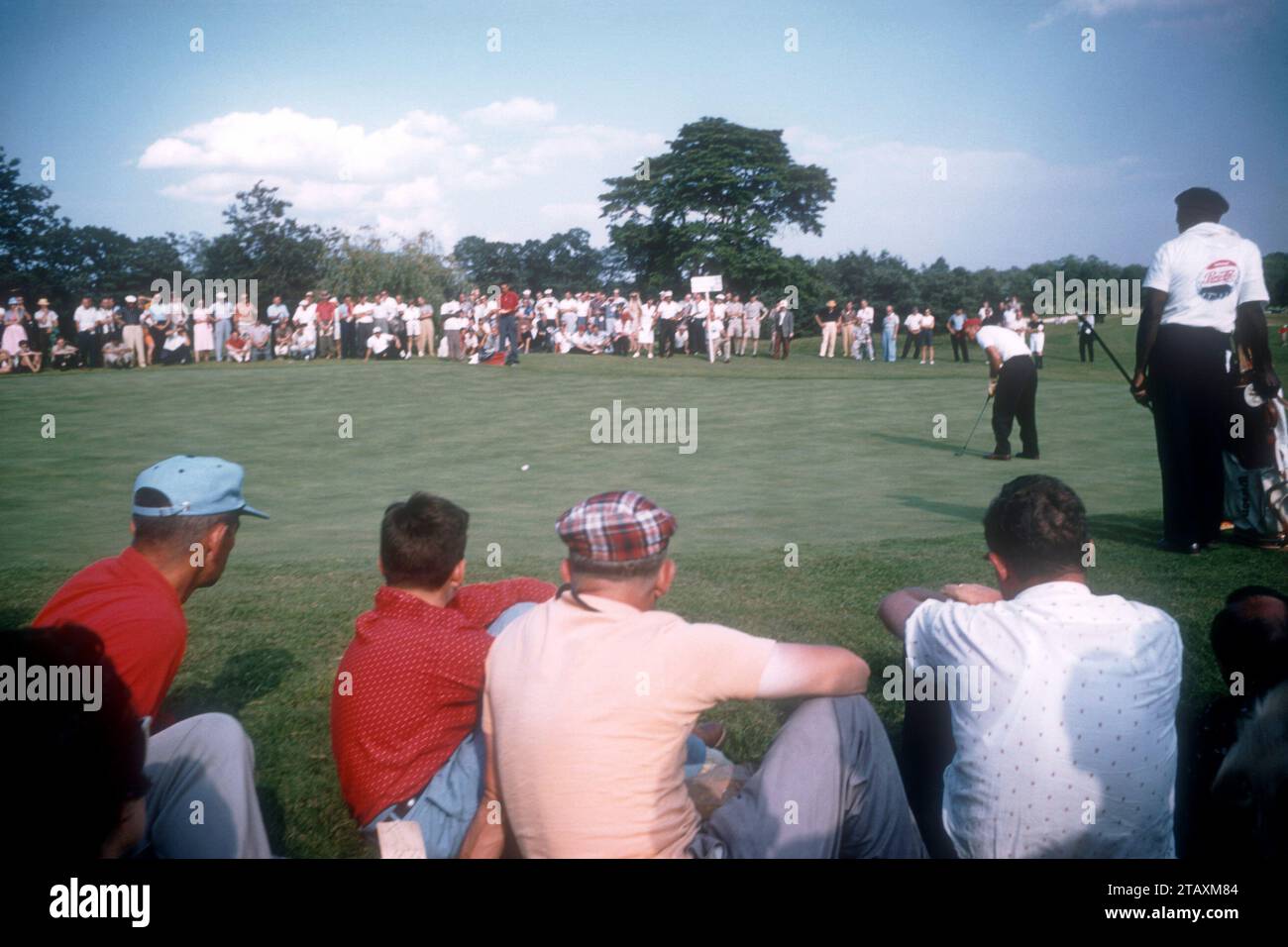 AUGUST, 1958: General view of the crowd watching the putted ball roll ...