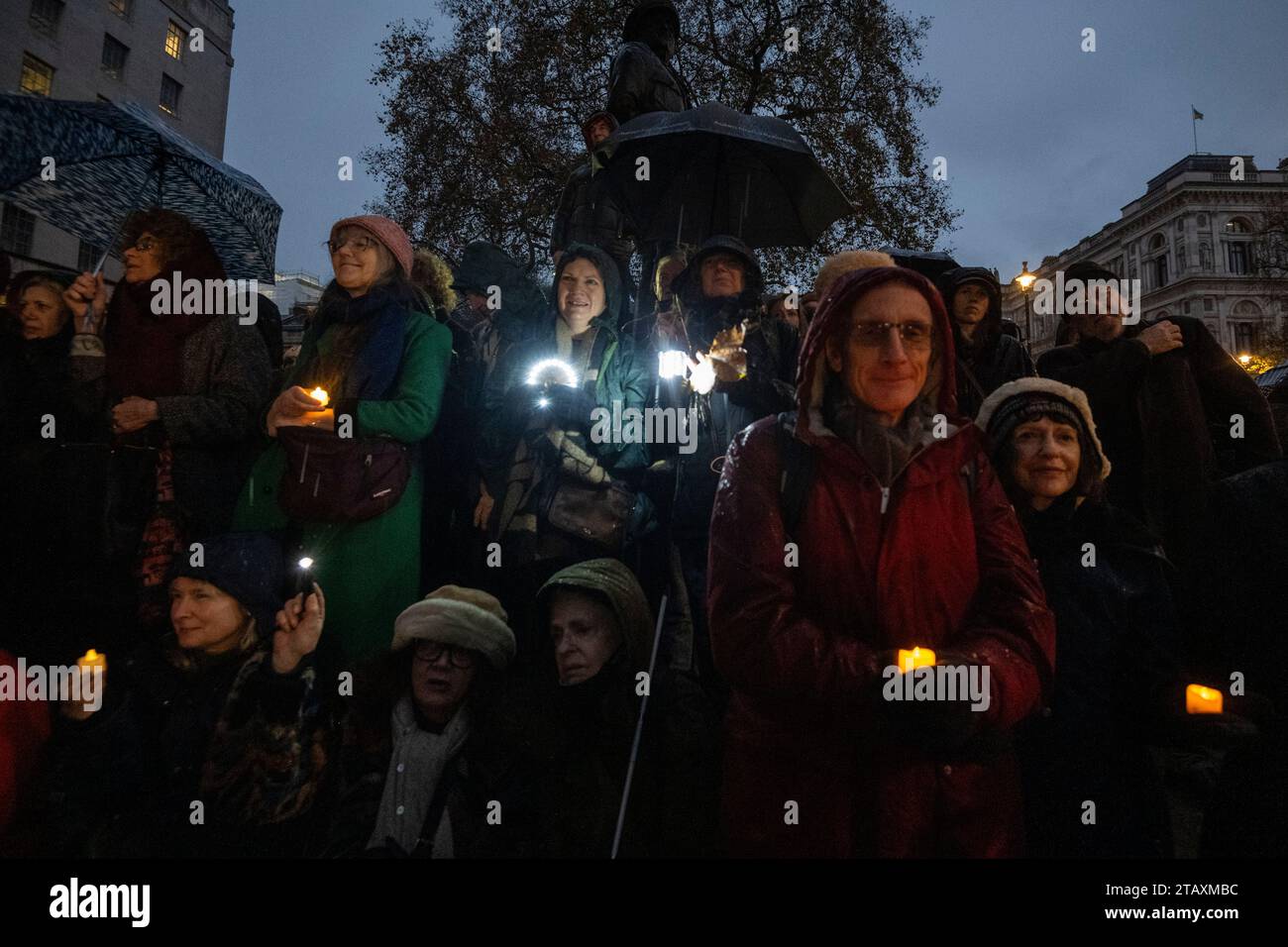 London, UK. 3 December 2023. People with candles and lanterns at a ...