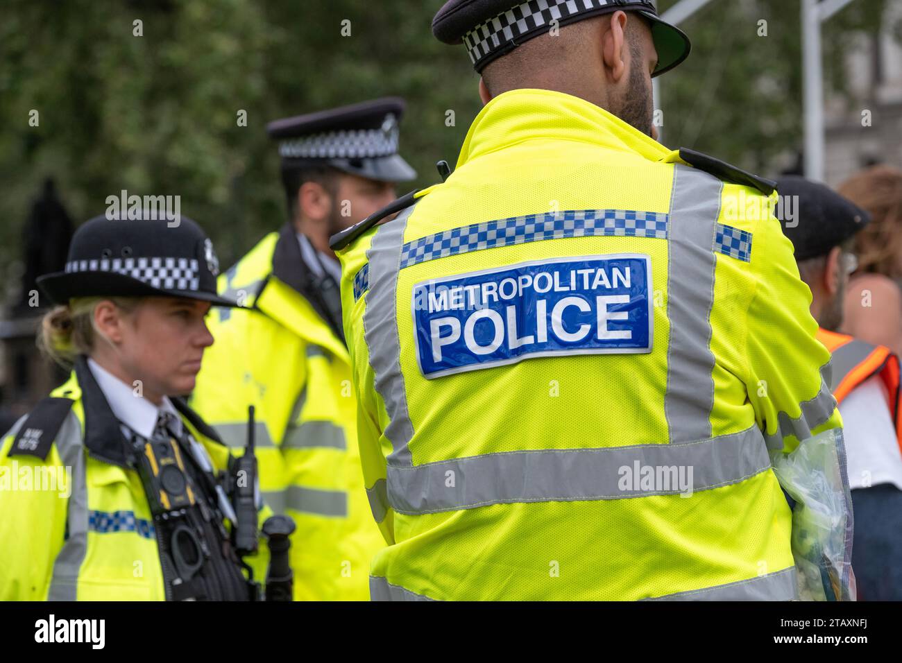 Metropolitan Police sign on the back of a high visibility jacket worn ...
