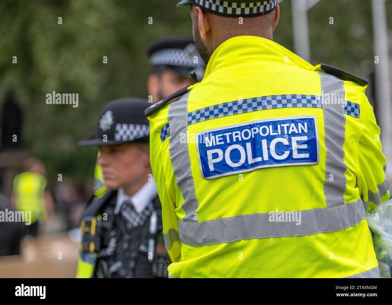 Metropolitan Police sign on the back of a high visibility jacket worn ... Metropolitan Police sign on the back of a high visibility jacket worn ...