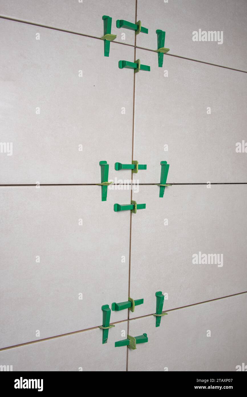 Tile leveling system with plastic clips and wedges, shot while the tile ...