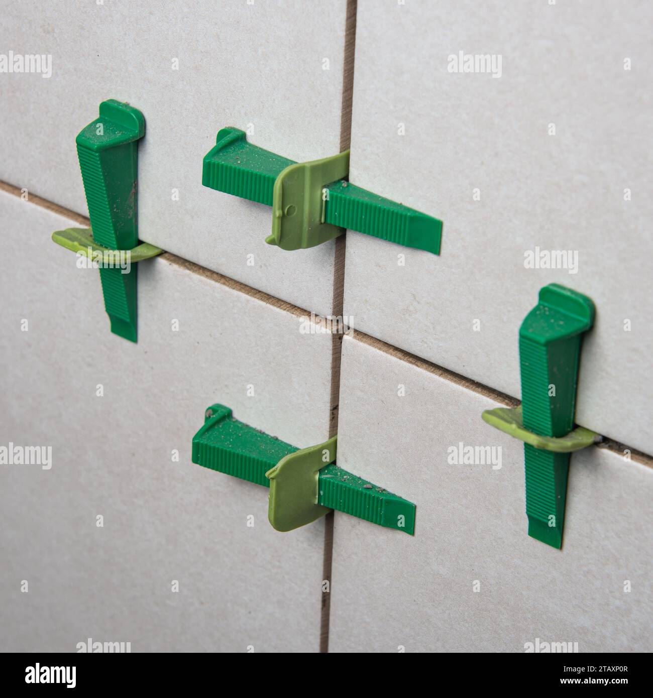 Tile leveling system with plastic clips and wedges, shot while the tile ...