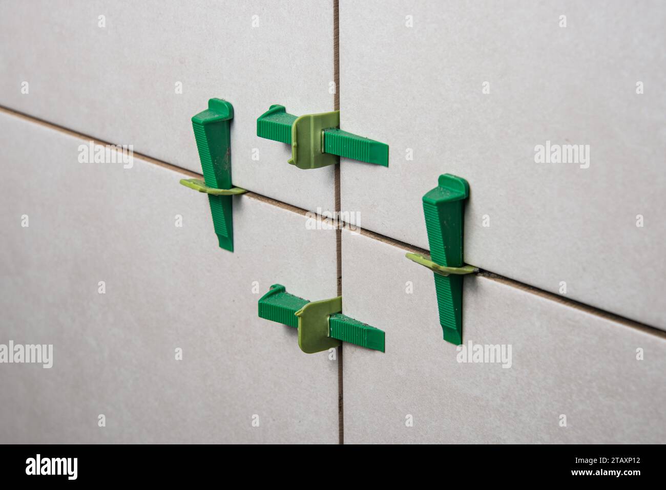 Tile leveling system with plastic clips and wedges, shot while the tile ...