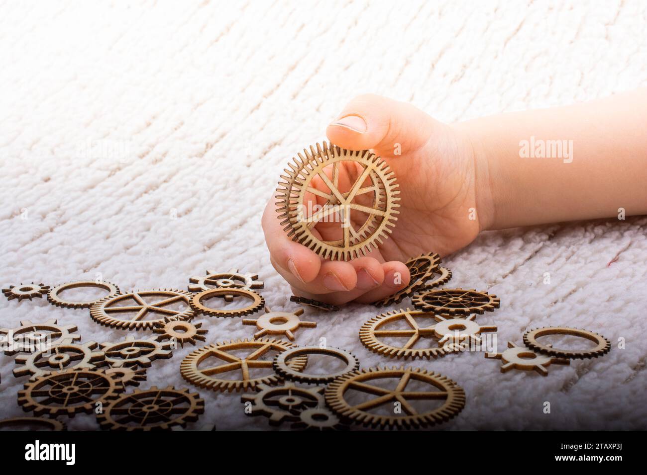 Hand holding gear wheels as the concept of mechanism Stock Photo - Alamy